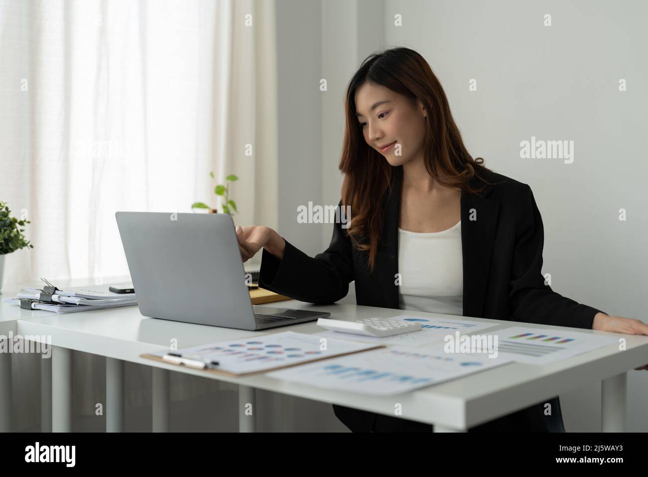 Asian accountant or financial expert analyze business report graph and ...