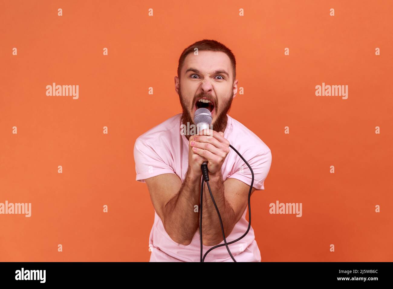 Man holding microphone hi-res stock photography and images - Alamy
