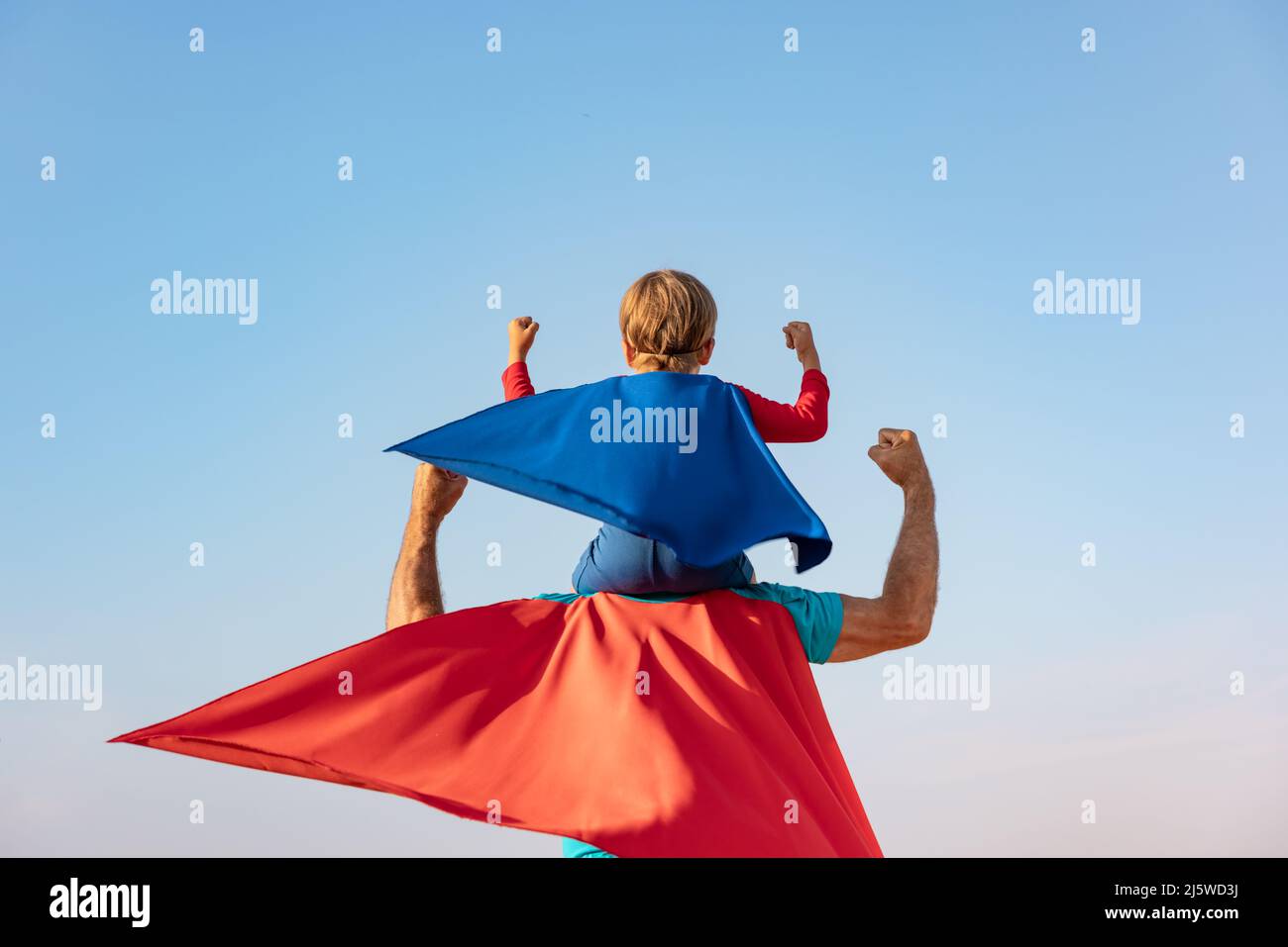 Superhero senior man and child playing outdoor. Super hero grandfather ...