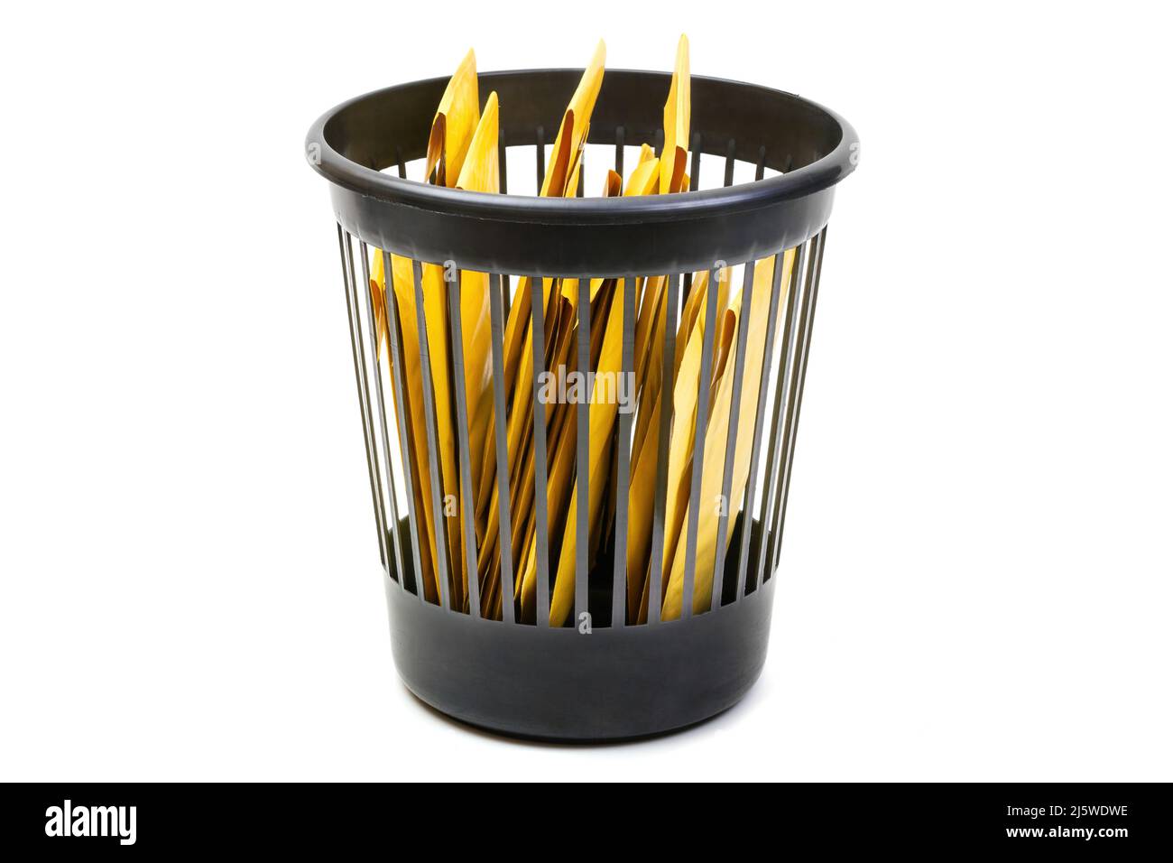 Bunch of yellow padded envelopes in a black plastic office bin isolated ...
