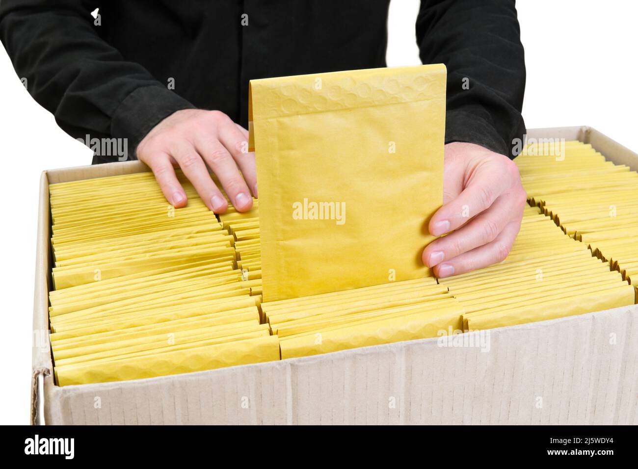 Person in black uniform inspecting a batch of yellow bubble envelopes ...