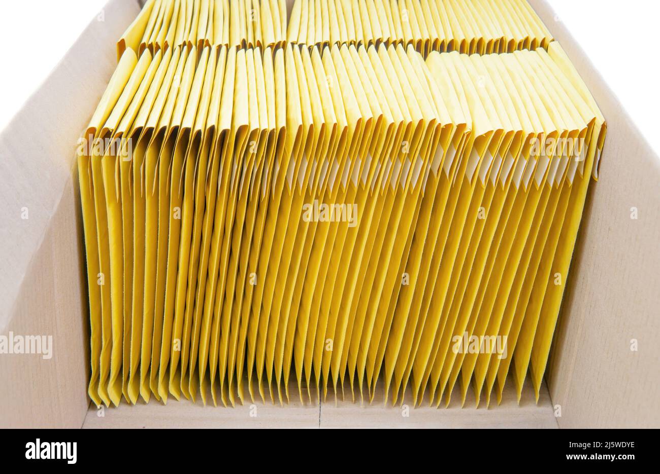 Bunch of yellow bubble envelopes stacked in a cardboard shipping box ...