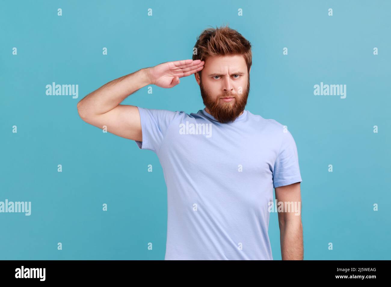 Portrait of responsible patriotic bearded man saluting with respect as ...