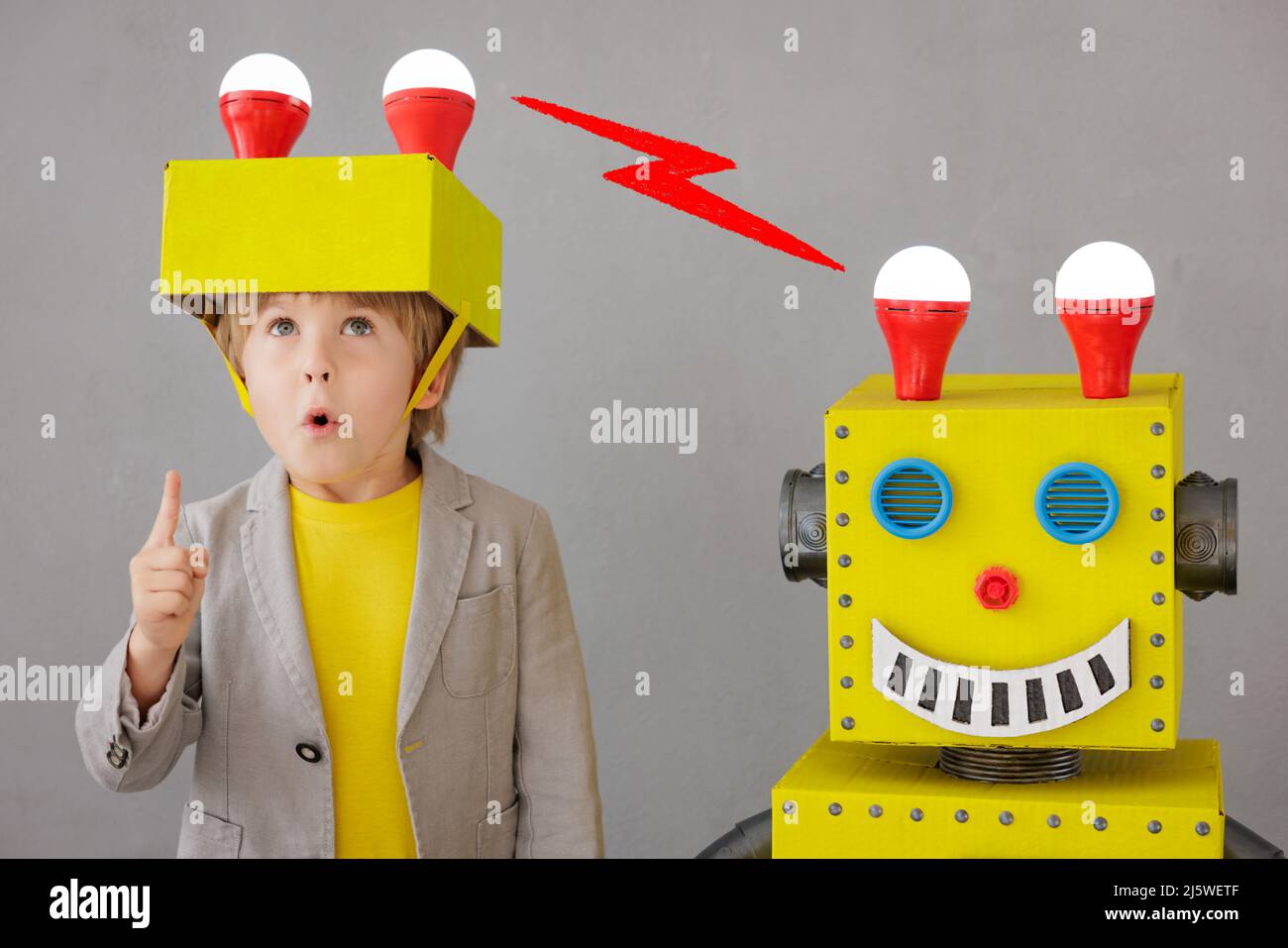 Happy child with robot. Funny kid playing at home. Success, creative ...