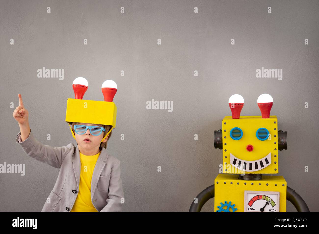 Happy child with robot. Funny kid playing at home. Success, creative ...