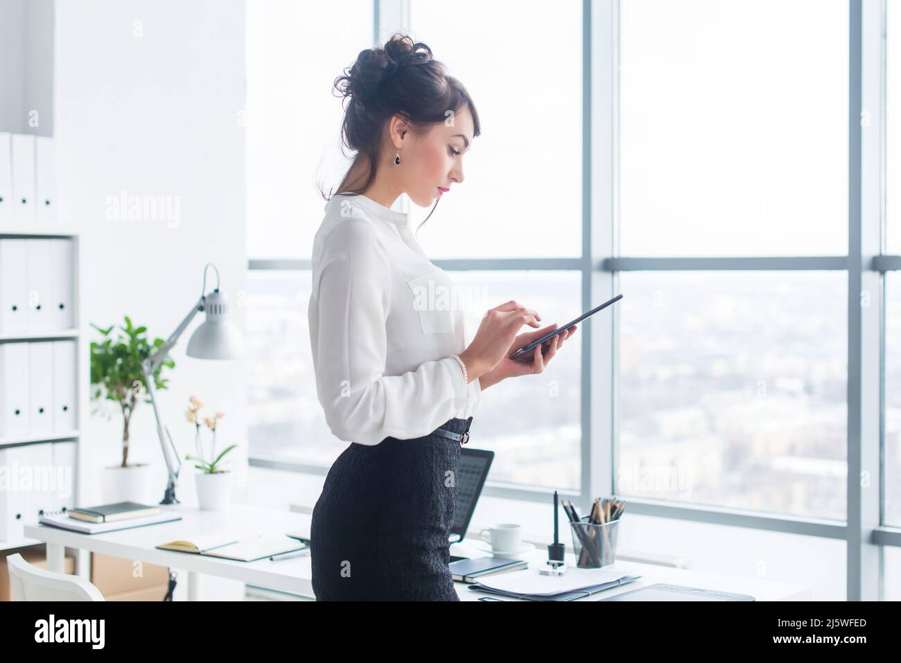 Close-up side view portrait of an employee texting, sending and reading ...