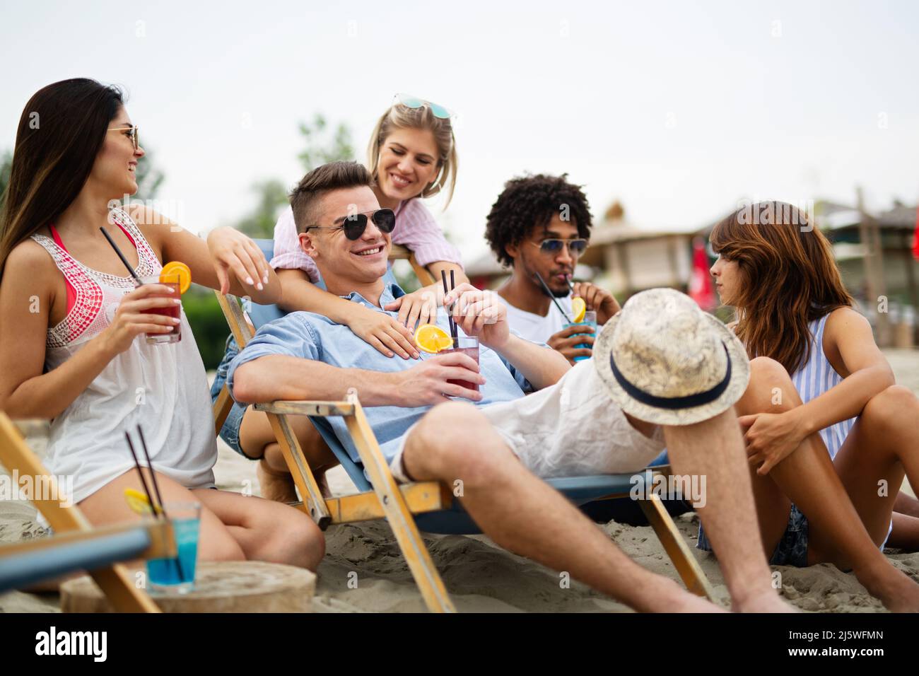 Portrait of friends having fun together on beach vacation. Student ...