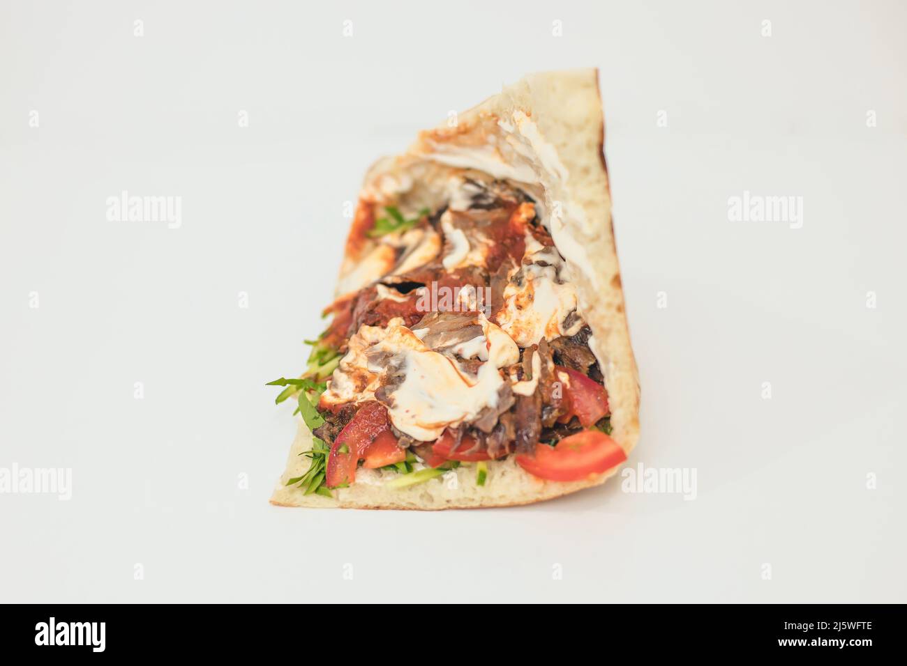 doner or shawarma in a Central Asian flatbread on a white background ...