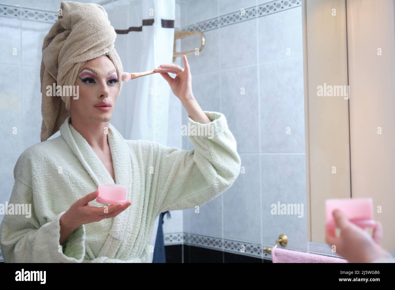 Drag queen person applying the blush to the cheeks after shower Stock ...