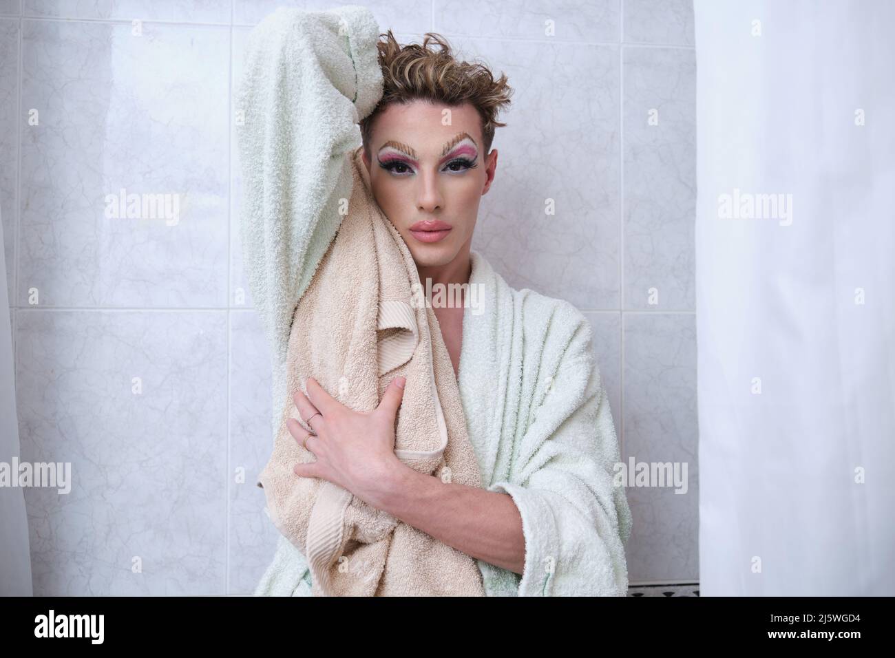 Drag queen person wearing bathrobe posing looking at camera in a ...