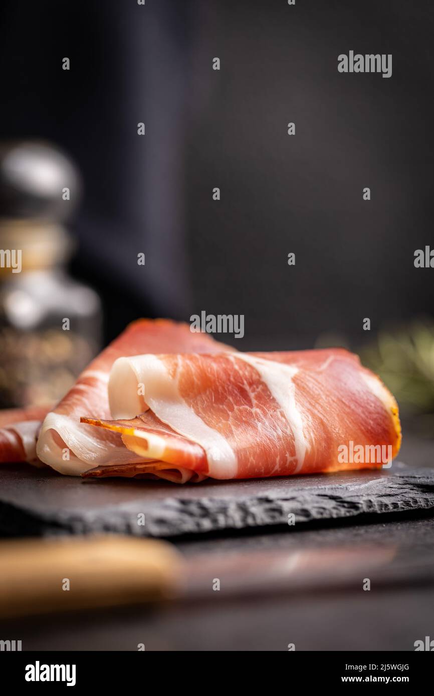 Sliced schwarzwald ham. Dried prosciutto ham on a cutting board Stock ...