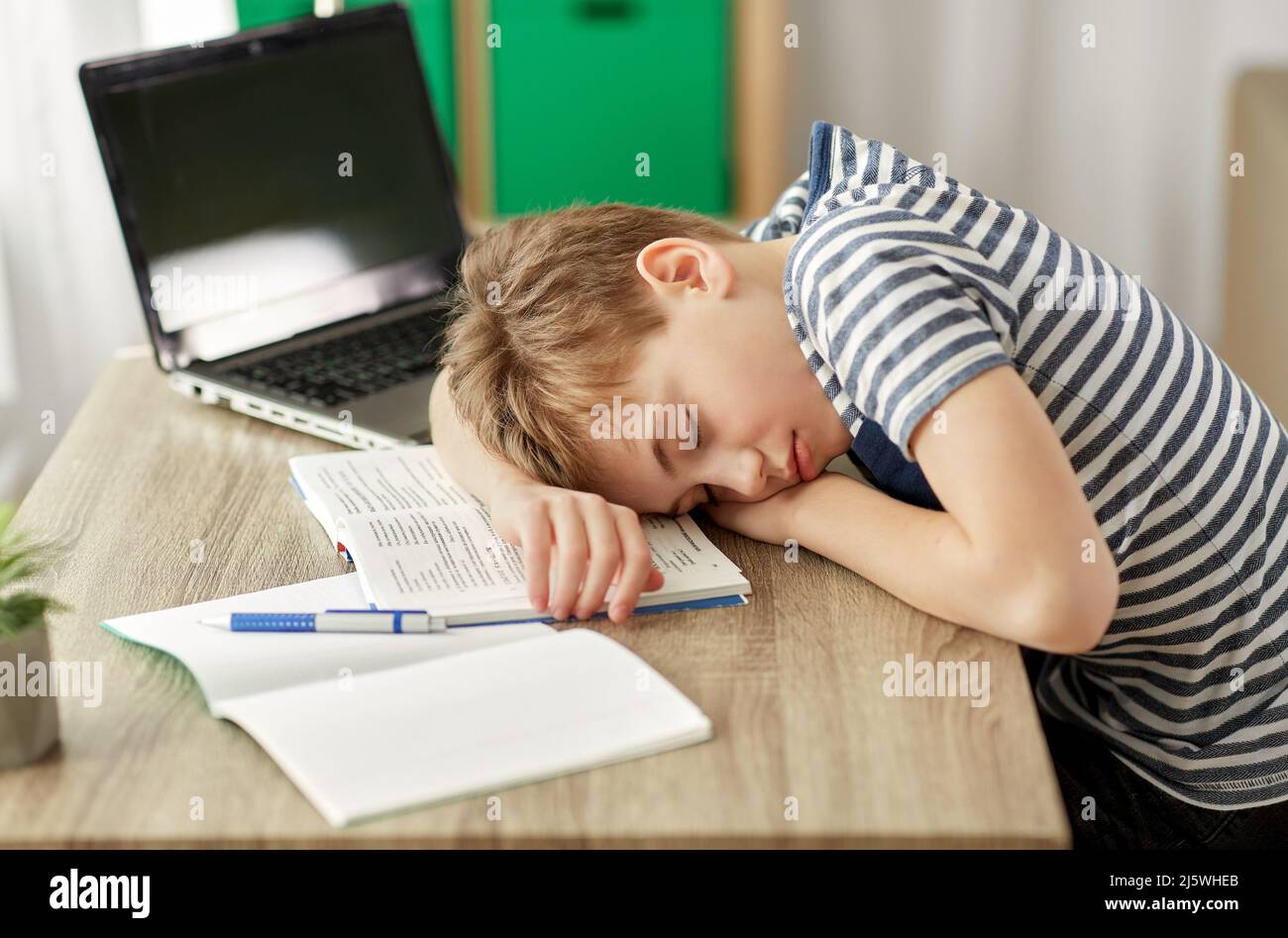 tired student boy sleeping on desk at home Stock Photo - Alamy