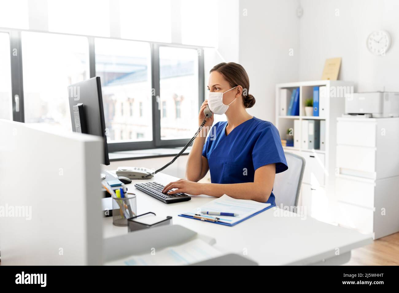 doctor with computer calling on phone at hospital Stock Photo - Alamy