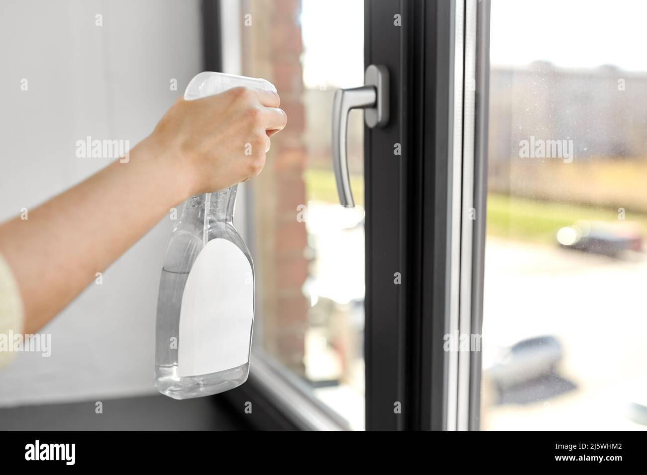 hands cleaning window handle with detergent Stock Photo - Alamy