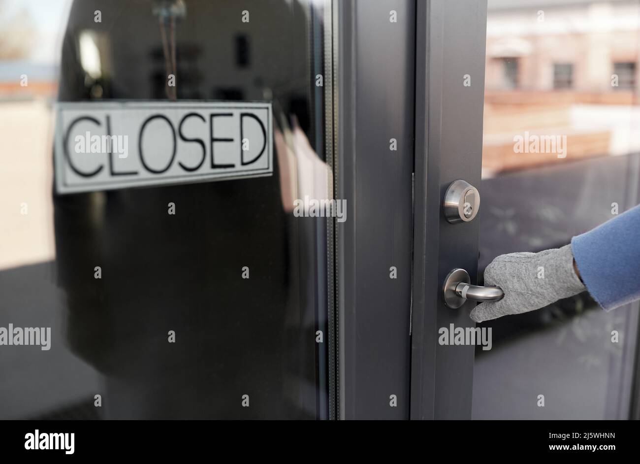 Woman trying door handle hi-res stock photography and images - Alamy