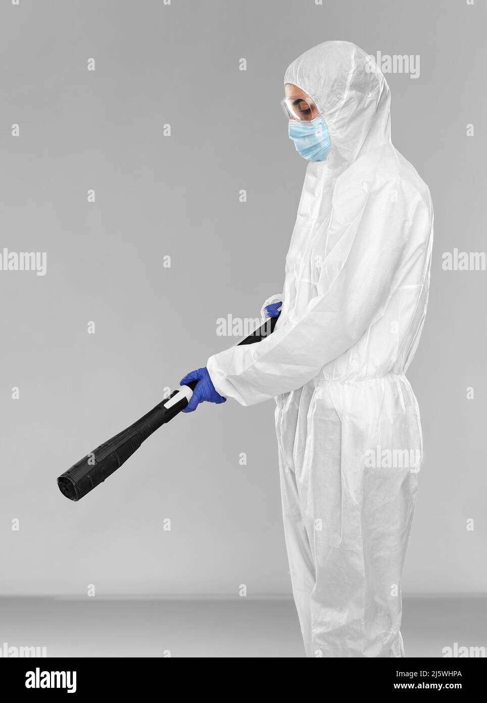 sanitation worker in hazmat with pressure washer Stock Photo - Alamy