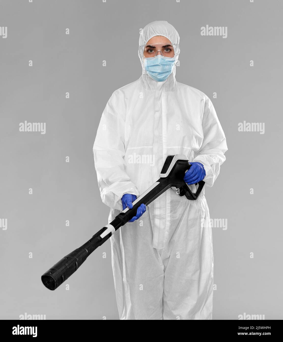 sanitation worker in hazmat with pressure washer Stock Photo - Alamy
