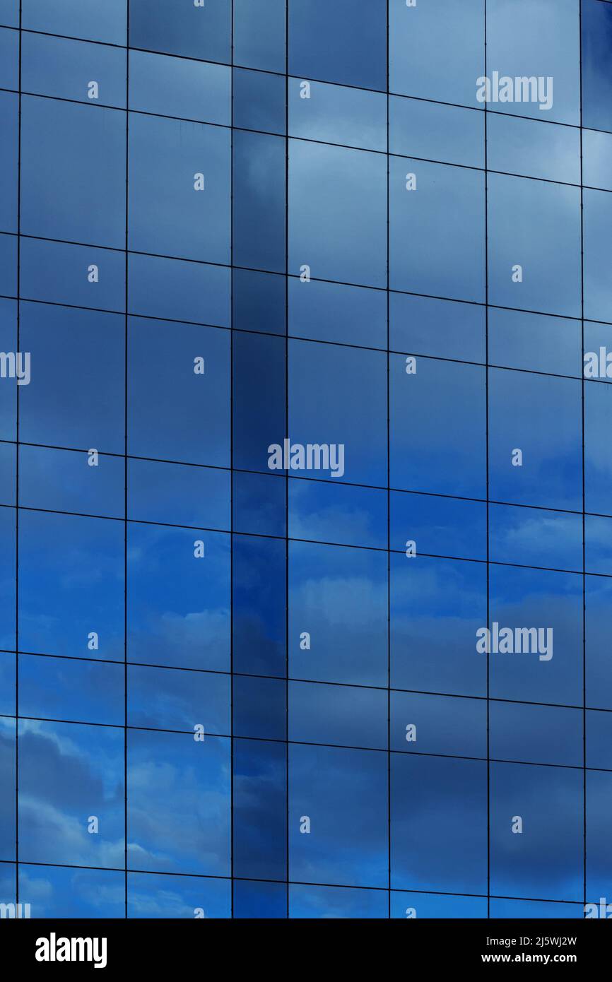 glass facade with blue sky and clouds reflected on it Stock Photo - Alamy