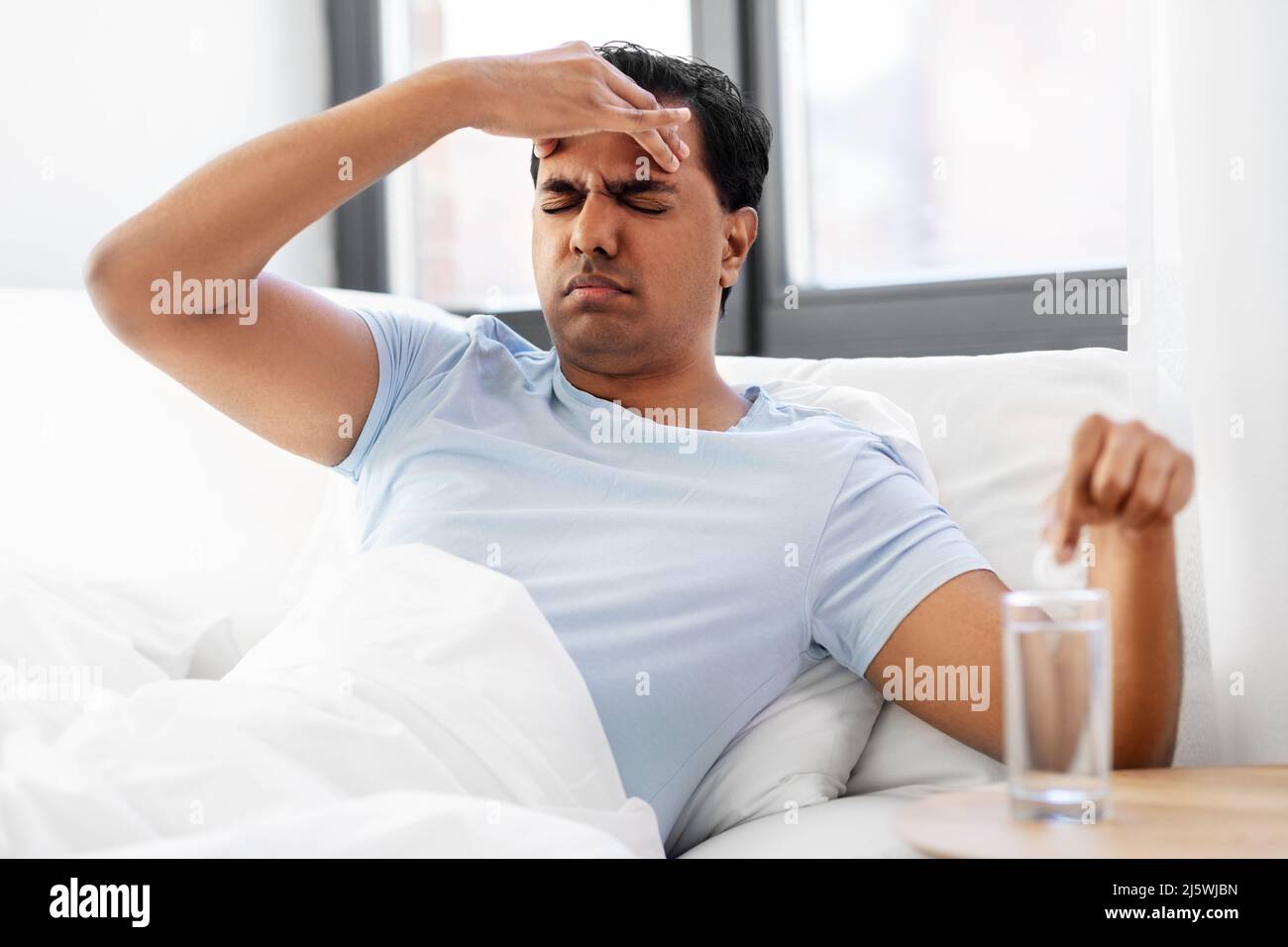 Sick man in bed hi-res stock photography and images - Alamy