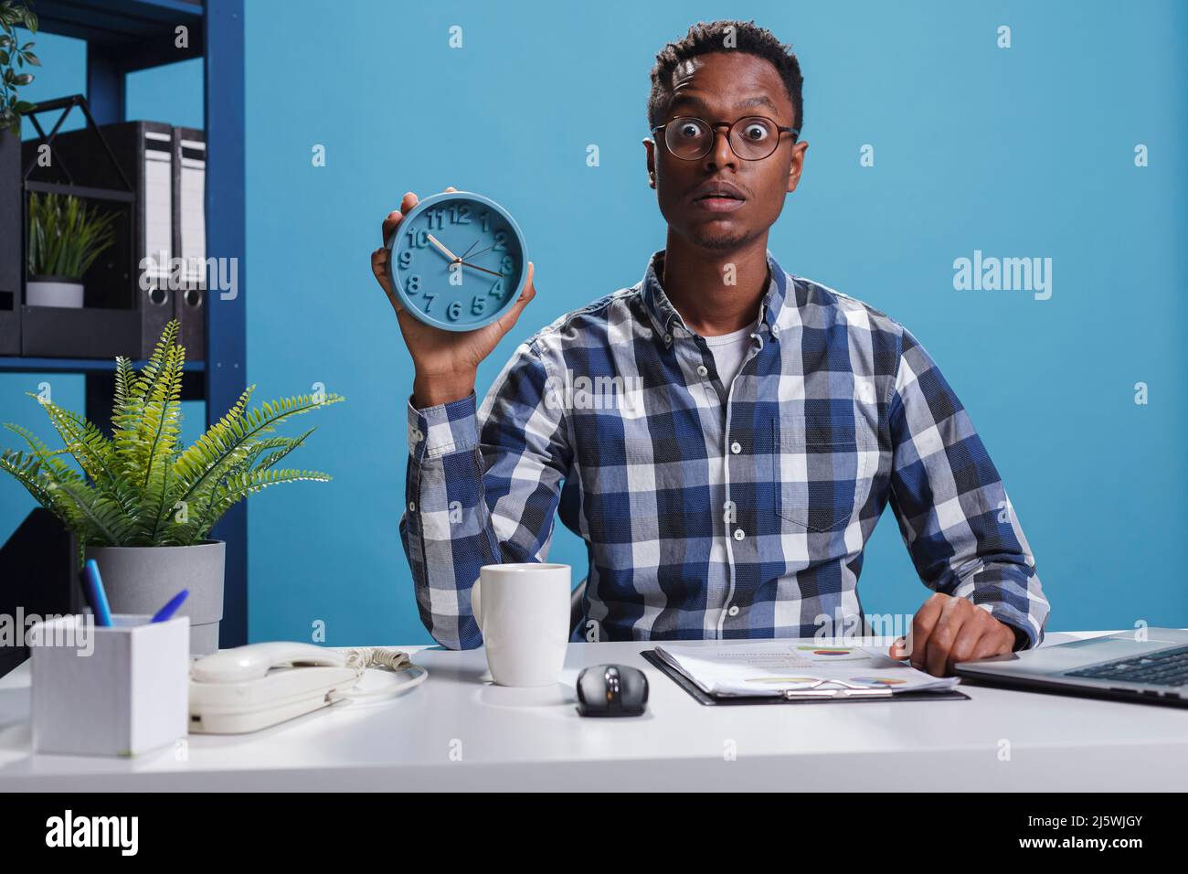 Shocked team leader nagging coworker for being late again while showing ...