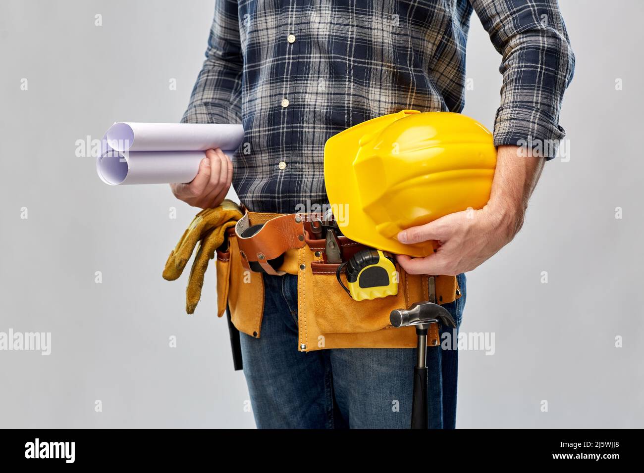 builder with helmet, blueprint and working tools Stock Photo - Alamy