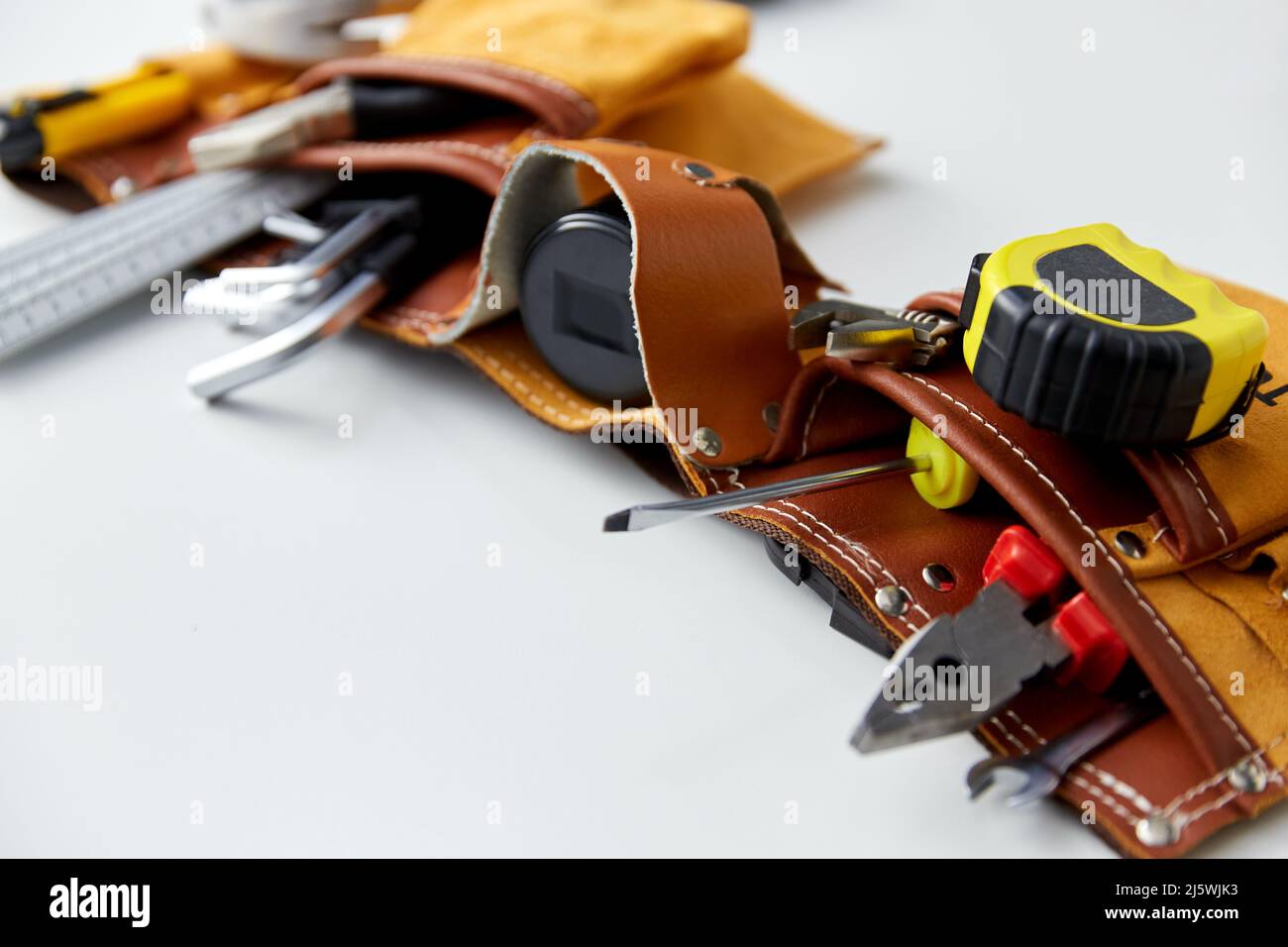 different work tools in belt on white background Stock Photo - Alamy
