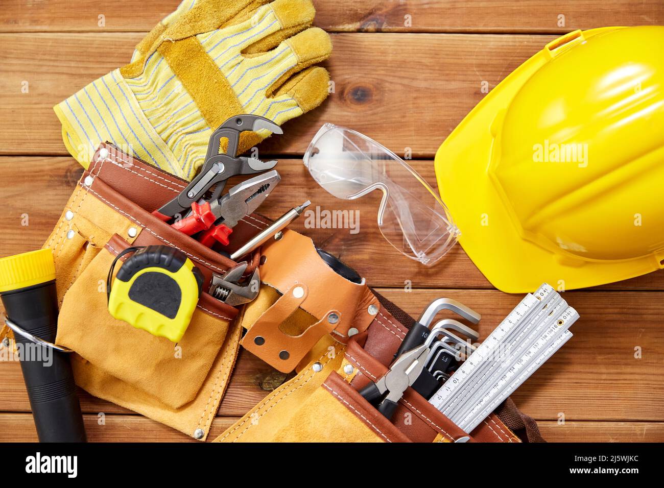 different work tools in belt on wooden boards Stock Photo - Alamy