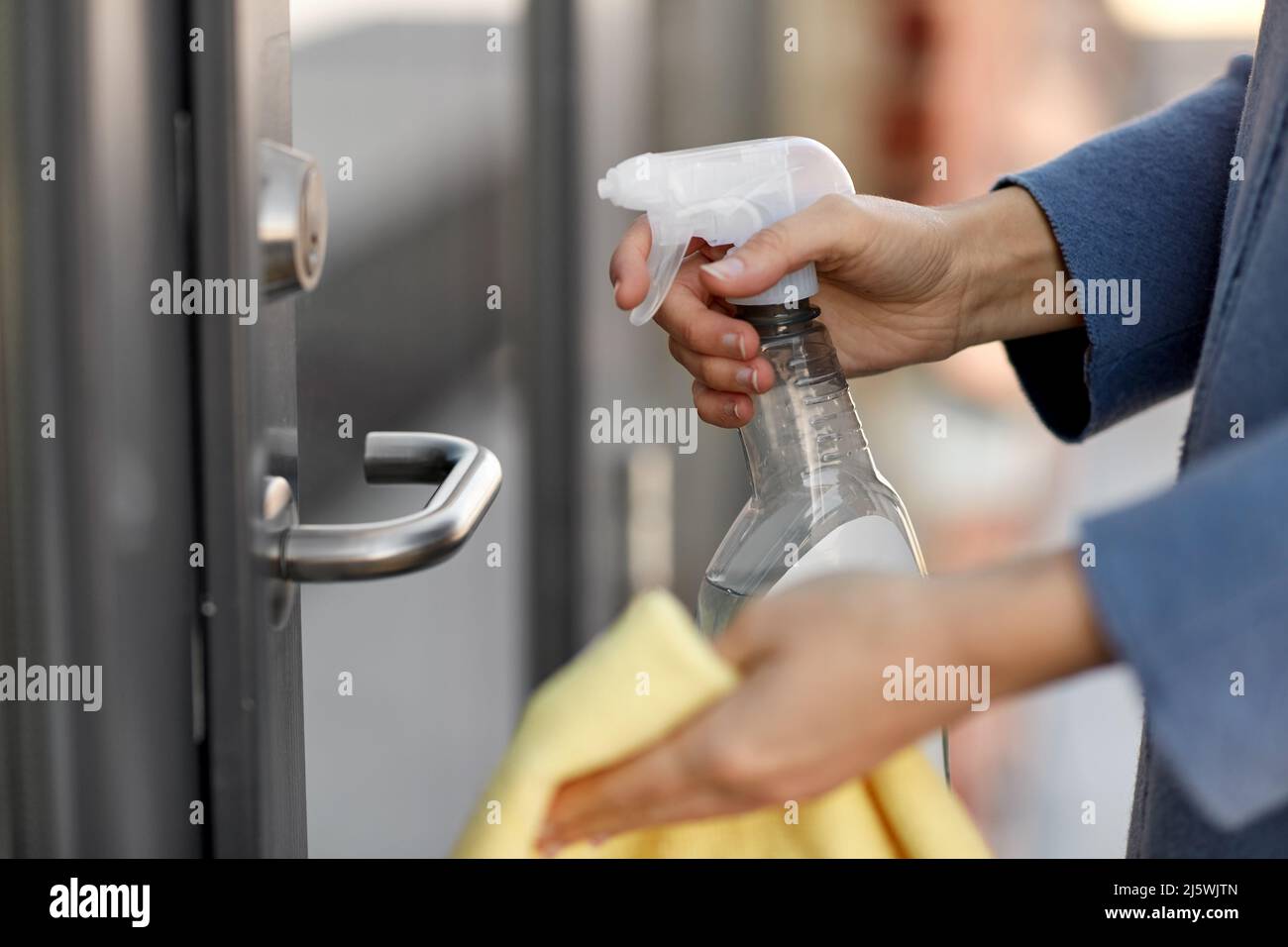 hand cleaning door handle with detergent and rag Stock Photo - Alamy