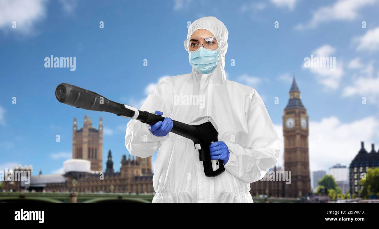 sanitation worker in hazmat with pressure washer Stock Photo - Alamy