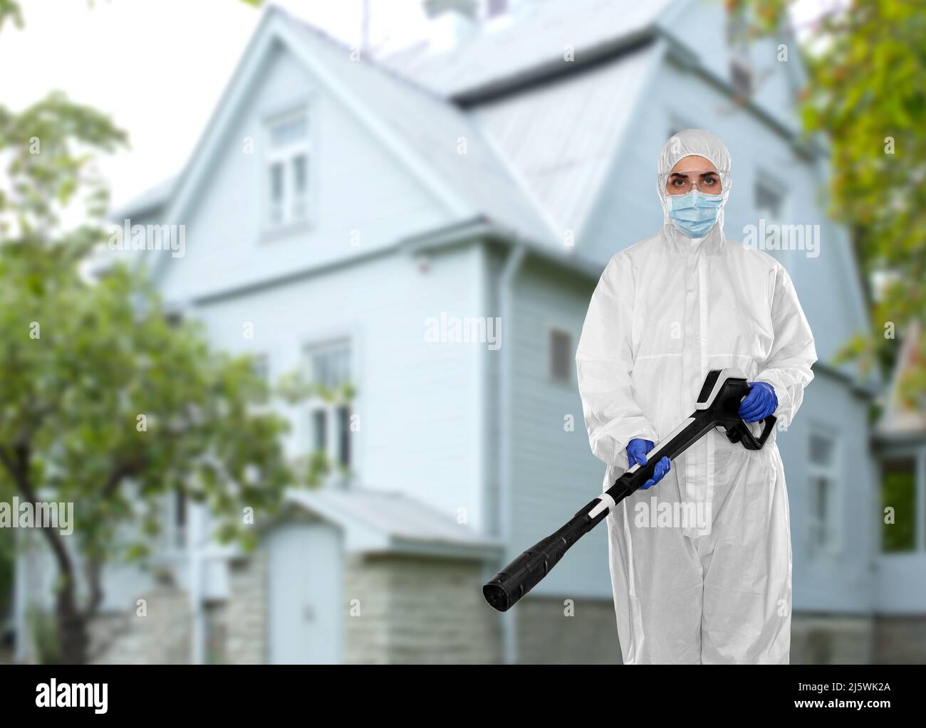 sanitation worker in hazmat with pressure washer Stock Photo - Alamy