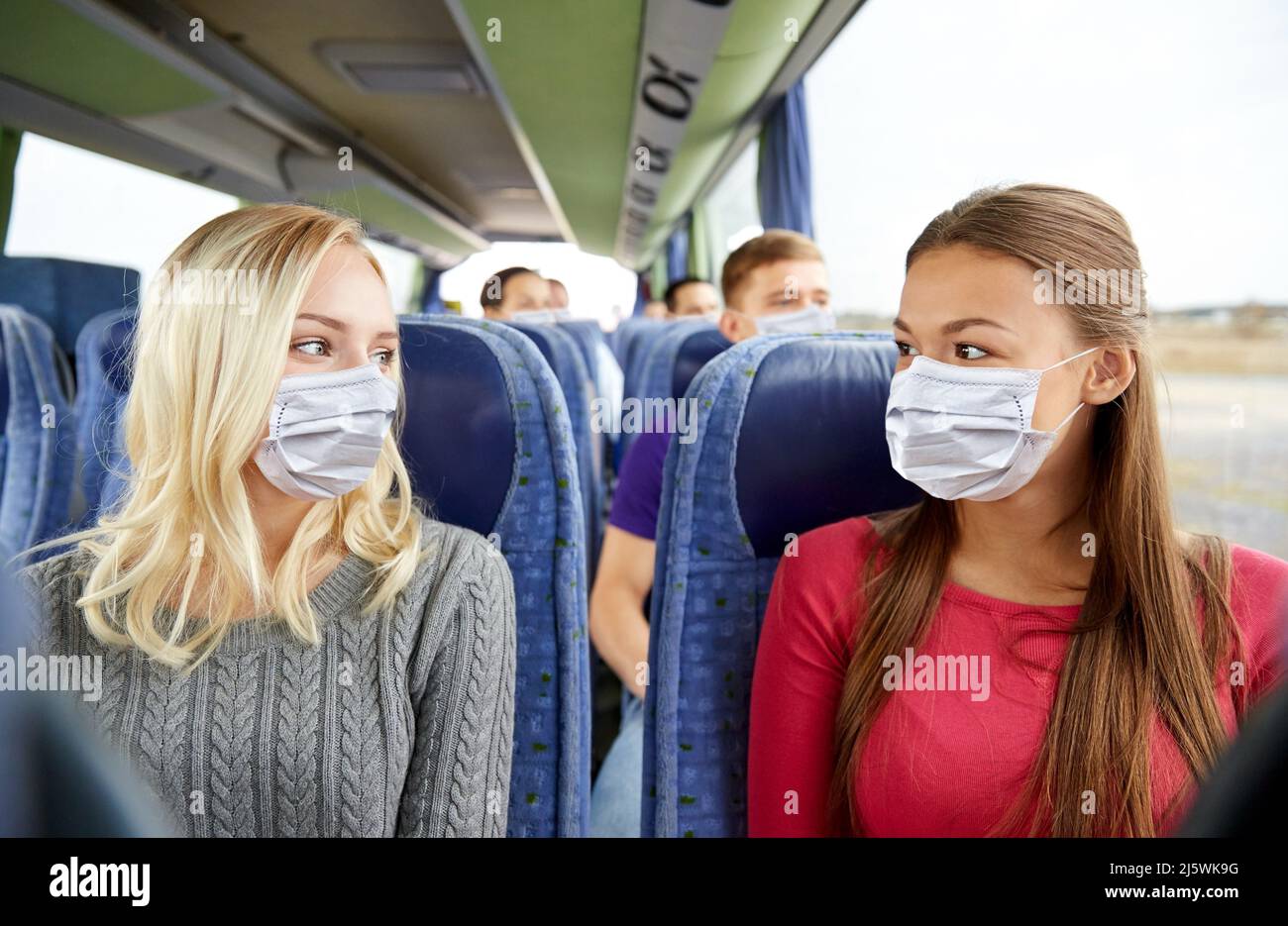 young women passengers in masks in travel bus Stock Photo - Alamy
