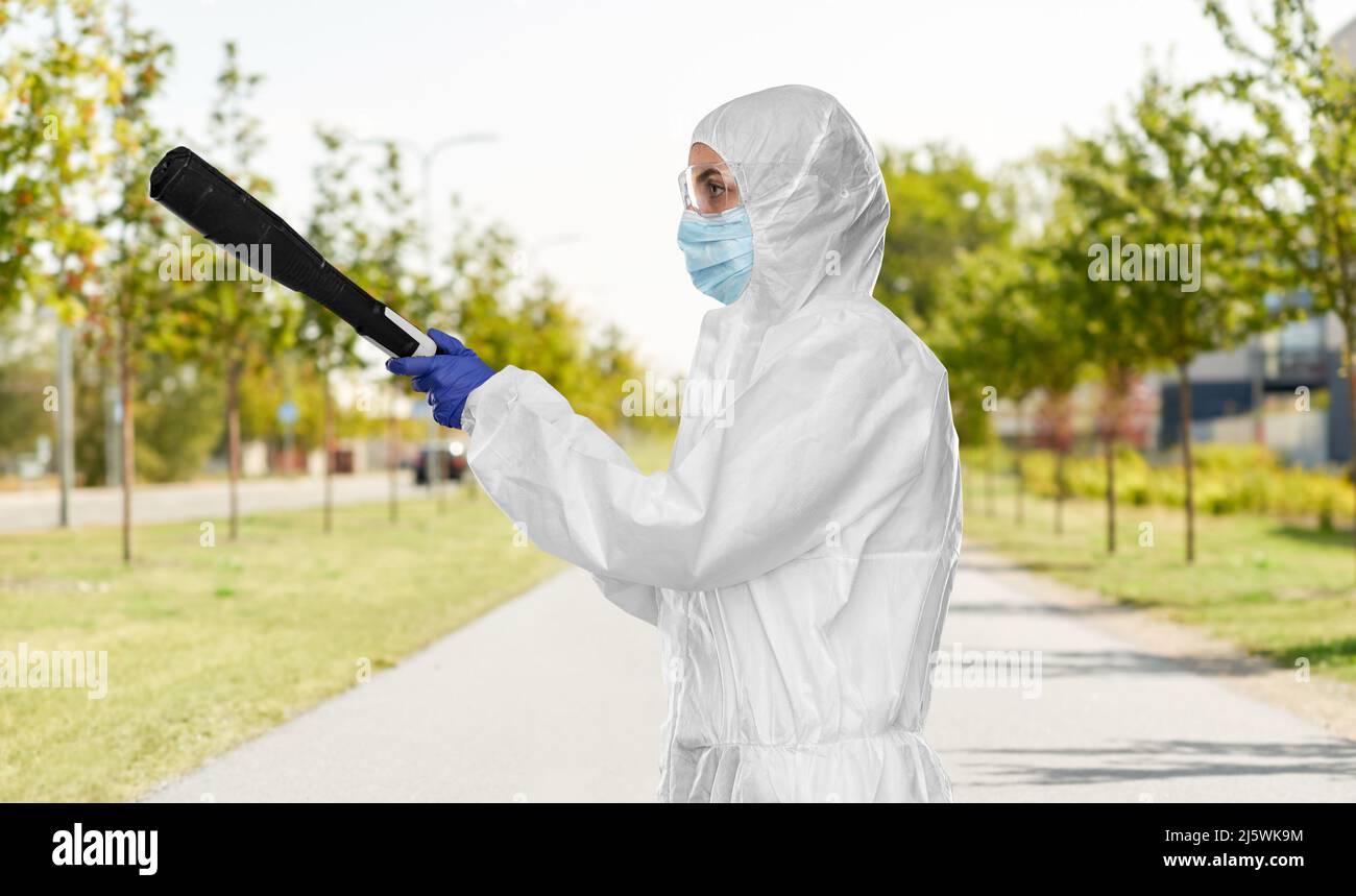 sanitation worker in hazmat with pressure washer Stock Photo - Alamy
