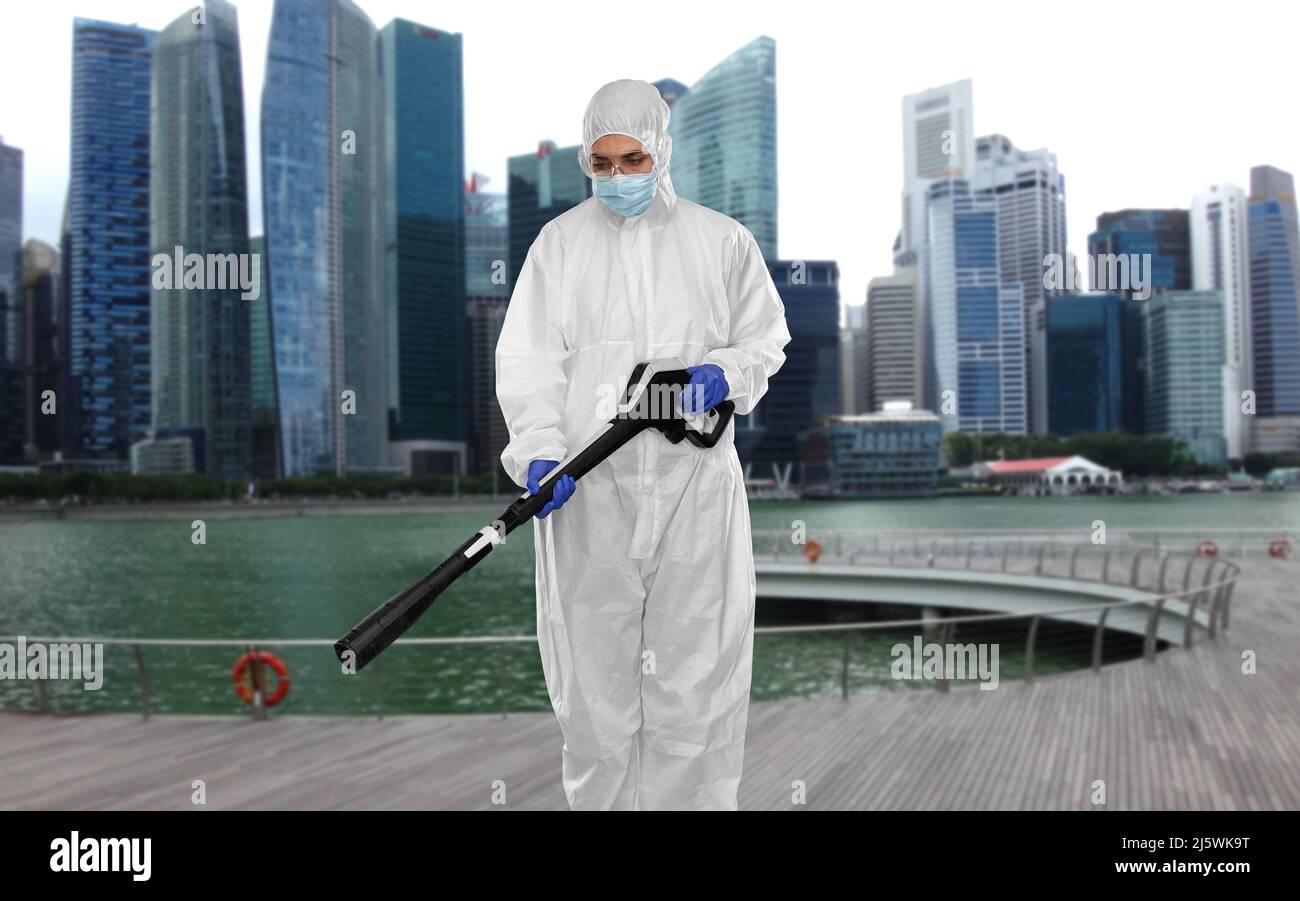 sanitation worker in hazmat with pressure washer Stock Photo - Alamy