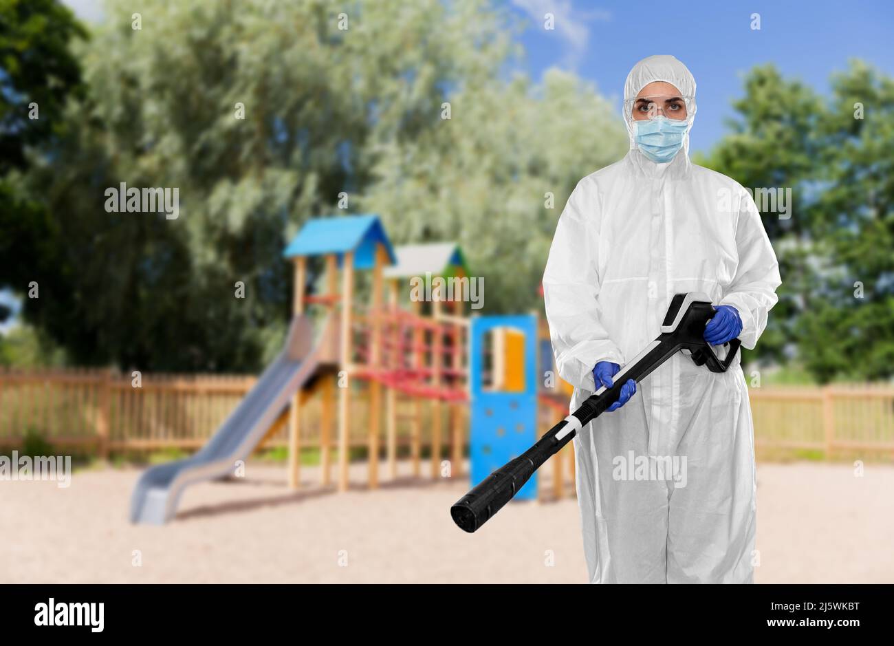 sanitation worker in hazmat with pressure washer Stock Photo - Alamy