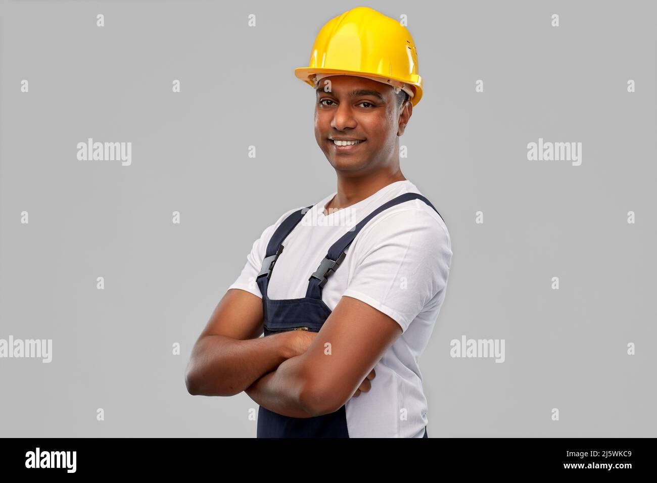 happy indian worker or builder with crossed arms Stock Photo - Alamy
