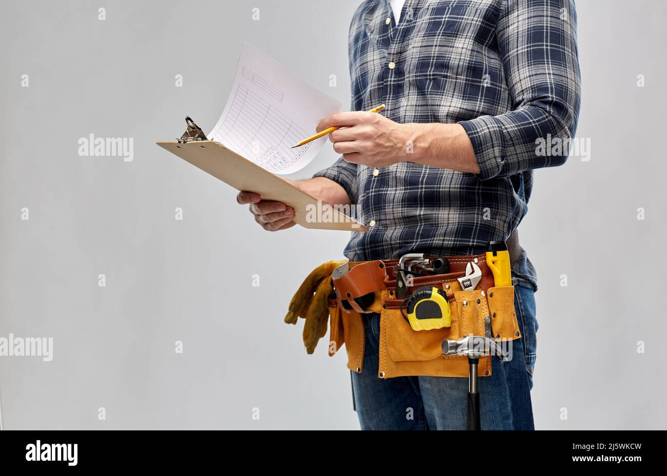 builder with clipboard, pencil and working tools Stock Photo - Alamy
