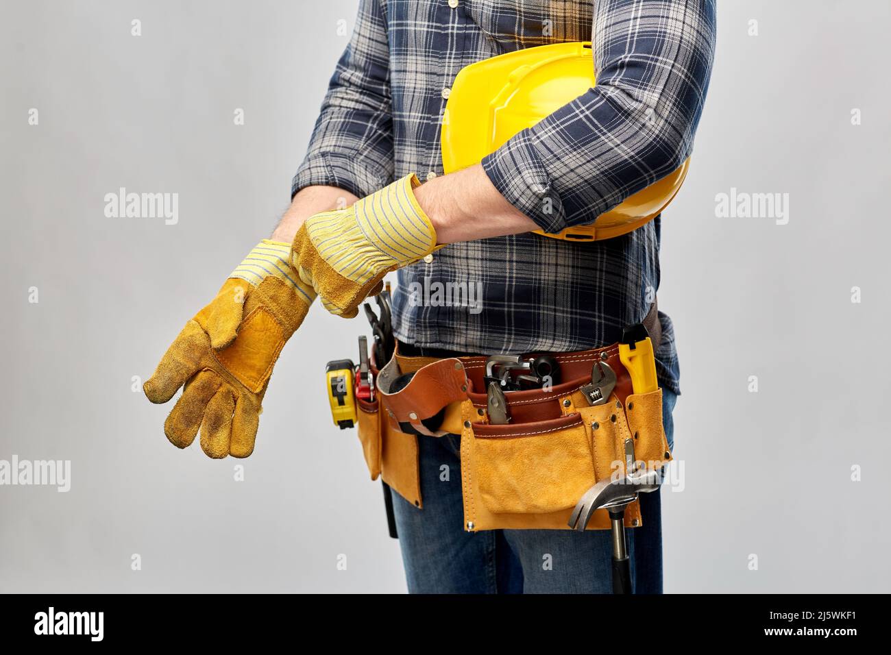 builder with gloves, helmet and working tools Stock Photo - Alamy