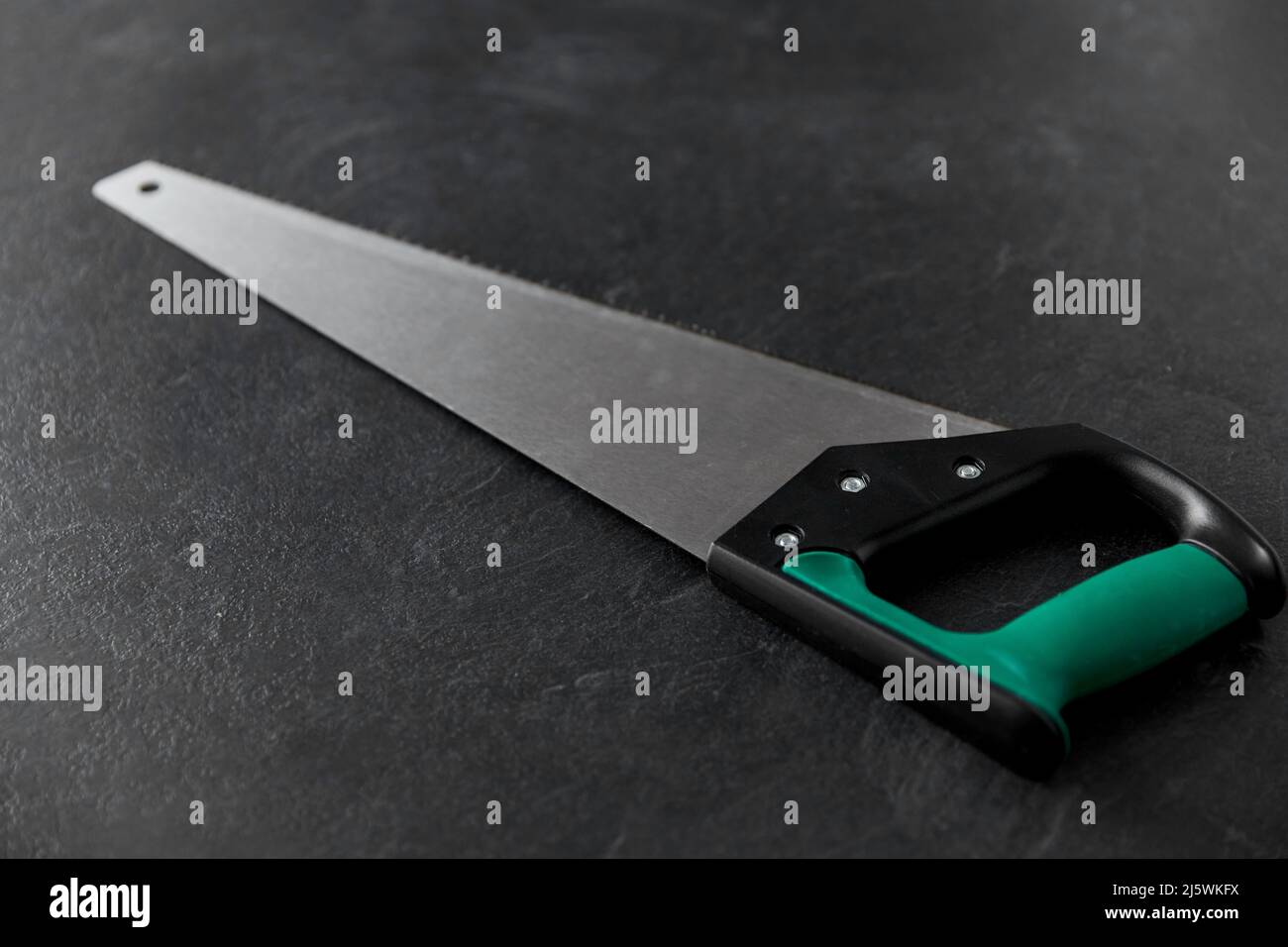 saw on slate background Stock Photo - Alamy