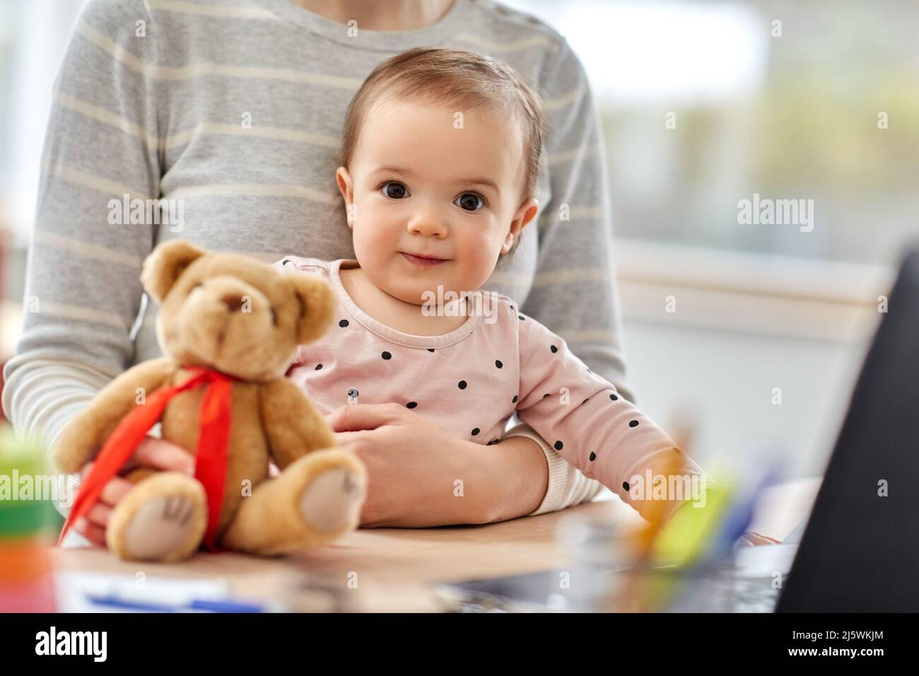 happy baby with mother working at home office Stock Photo - Alamy