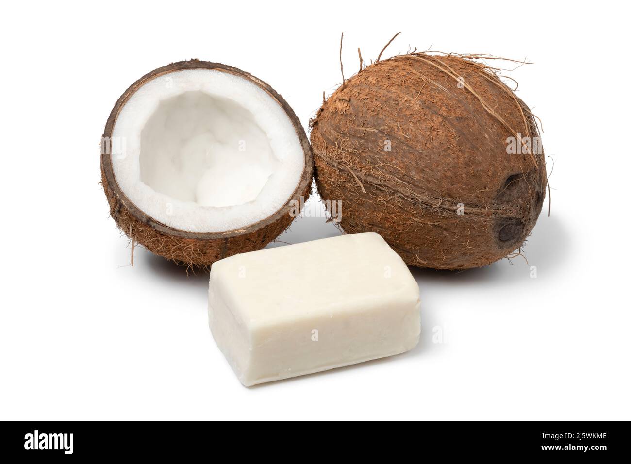 Piece of creamed coconut, coconut butter, close up and fresh coconuts ...