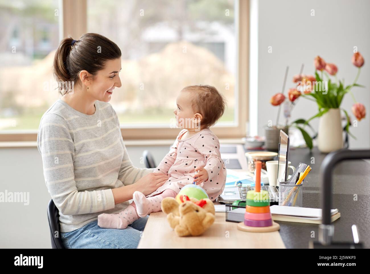 happy mother with baby working at home office Stock Photo - Alamy