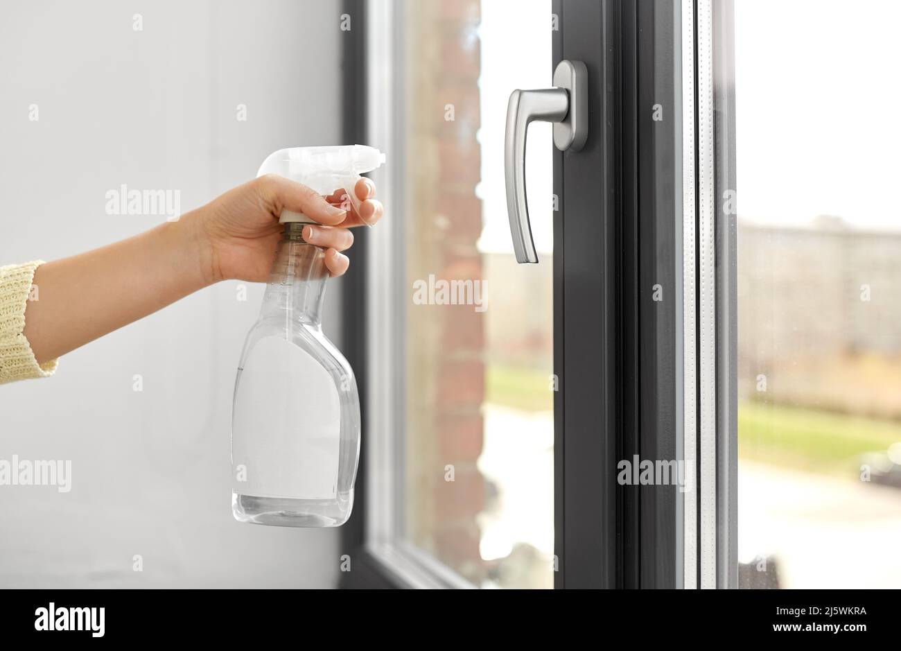 hands cleaning window handle with detergent Stock Photo - Alamy