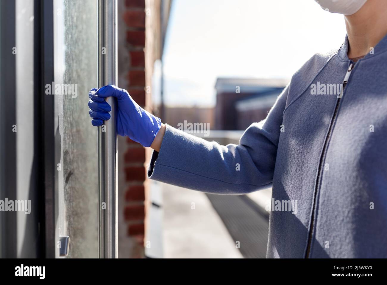 woman in protective glove trying to open door Stock Photo - Alamy