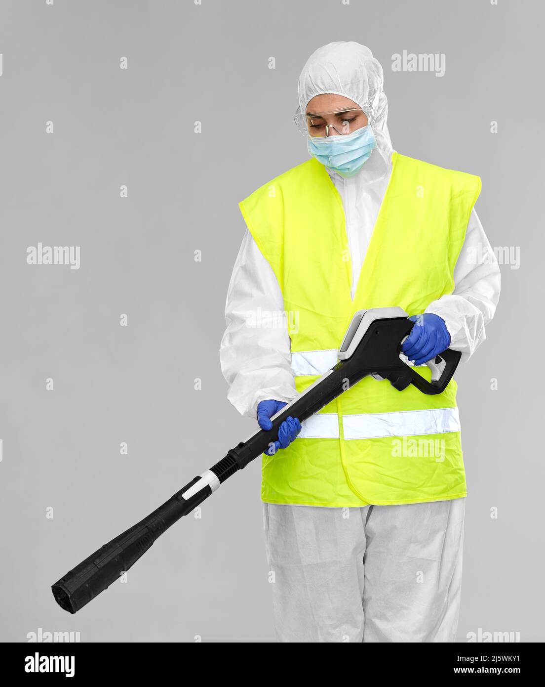 sanitation worker in hazmat with pressure washer Stock Photo - Alamy