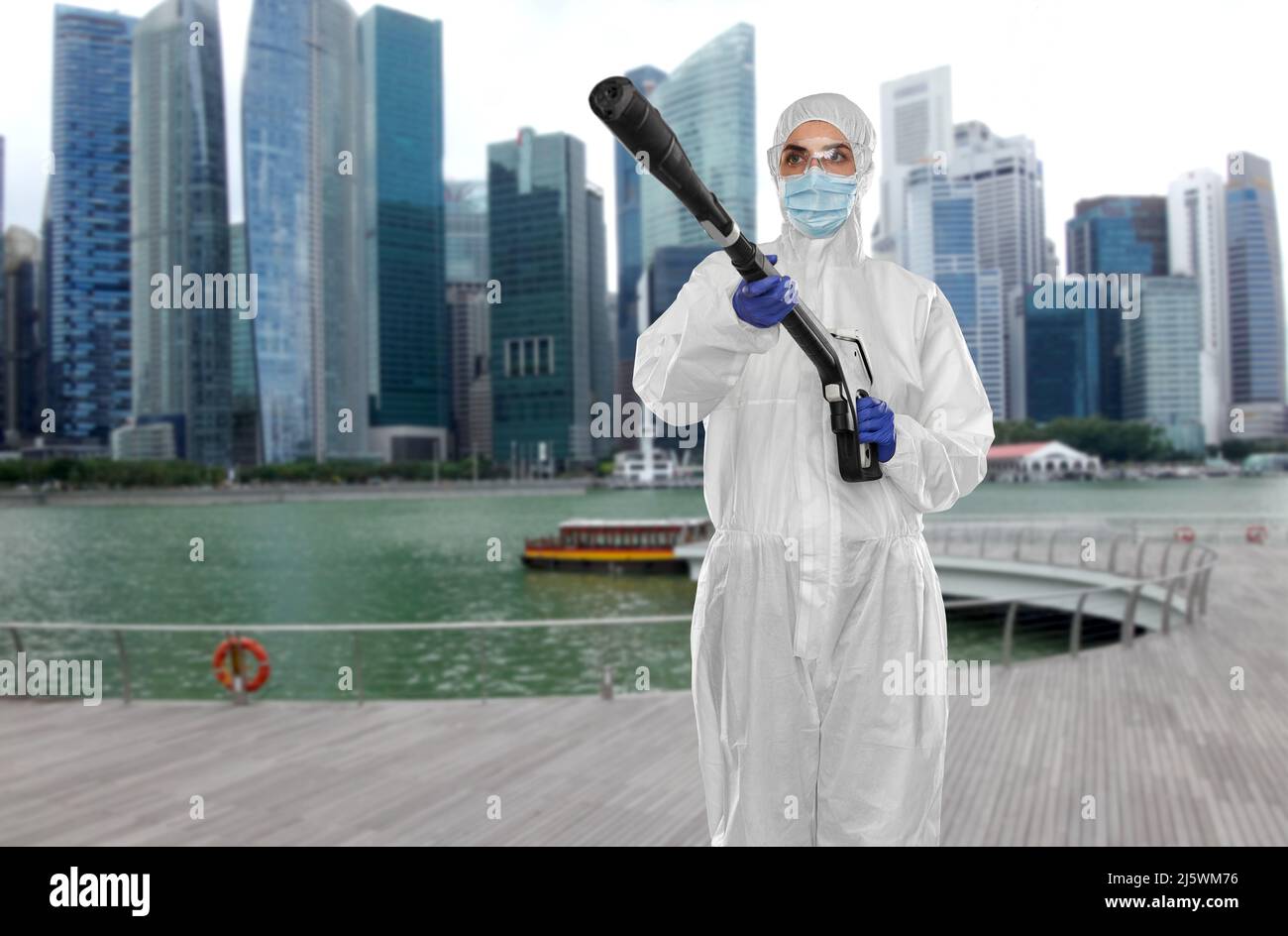sanitation worker in hazmat with pressure washer Stock Photo - Alamy
