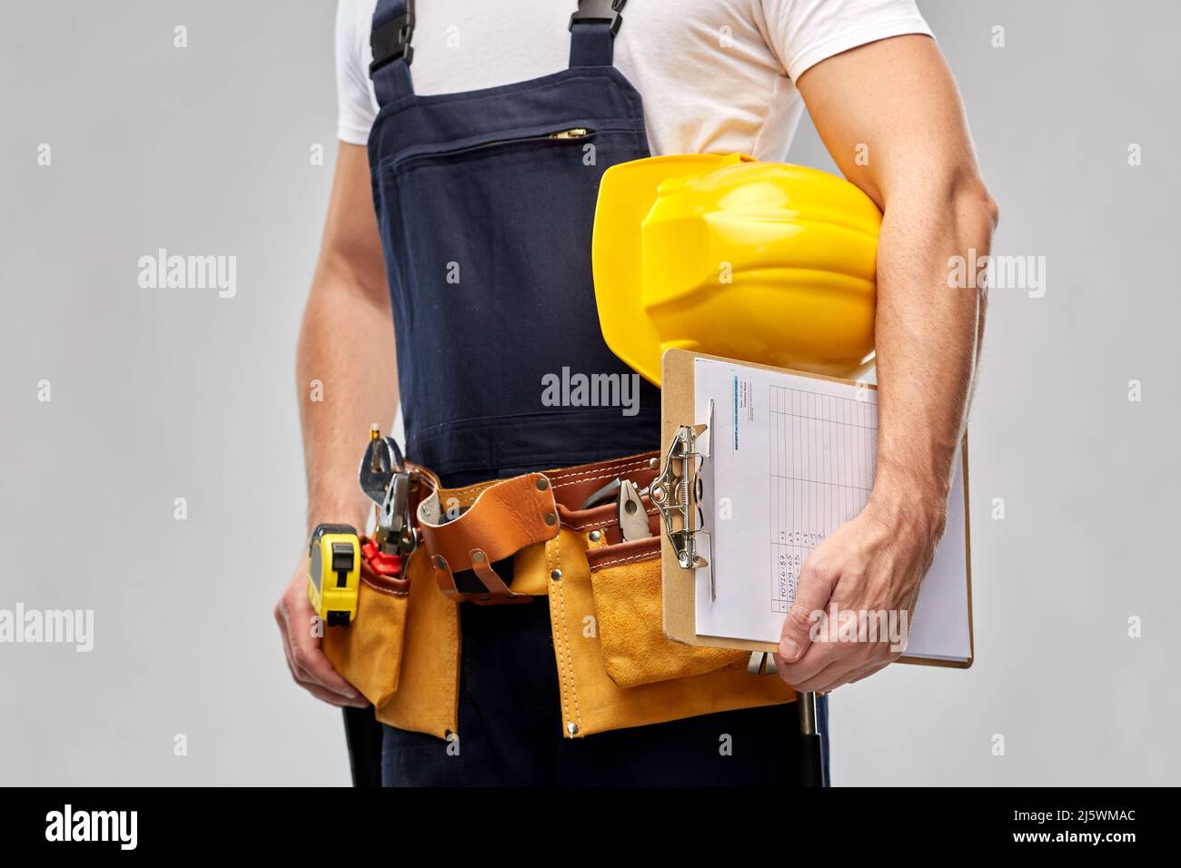 male builder with clipboard and working tools Stock Photo - Alamy