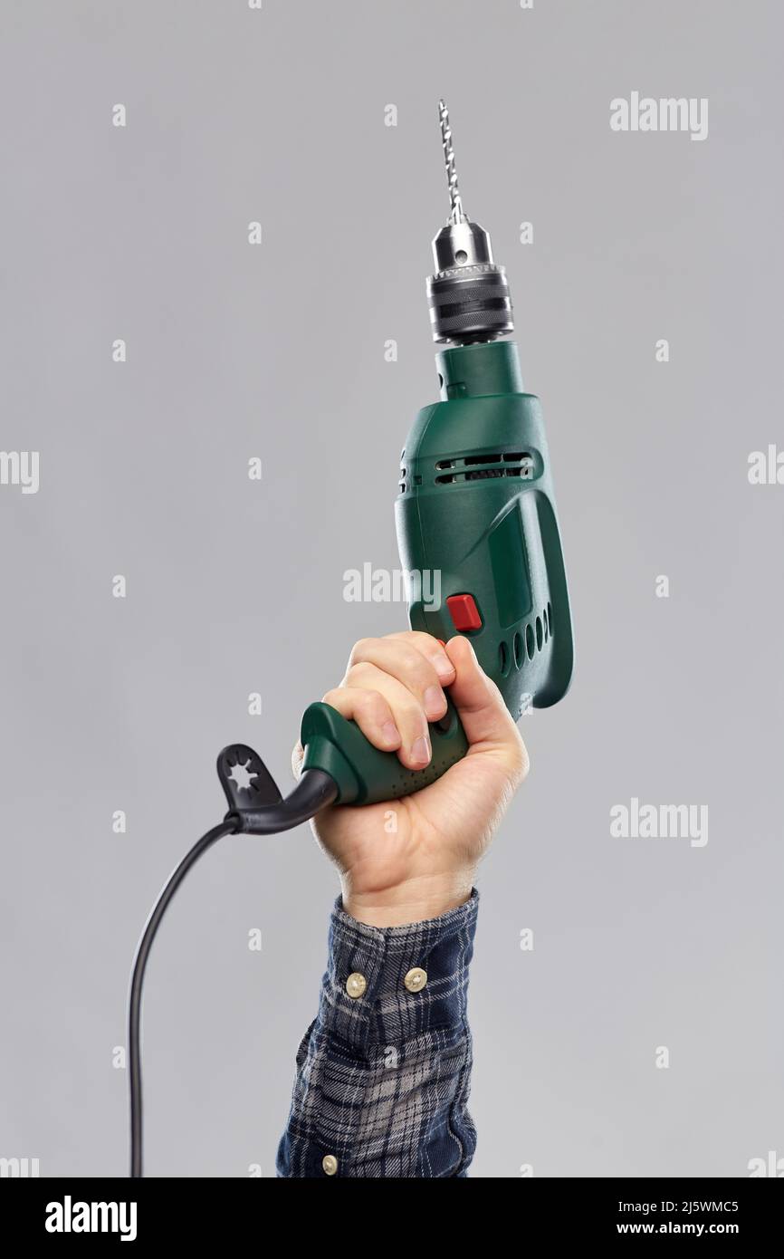 Hand holding drill hi-res stock photography and images - Alamy