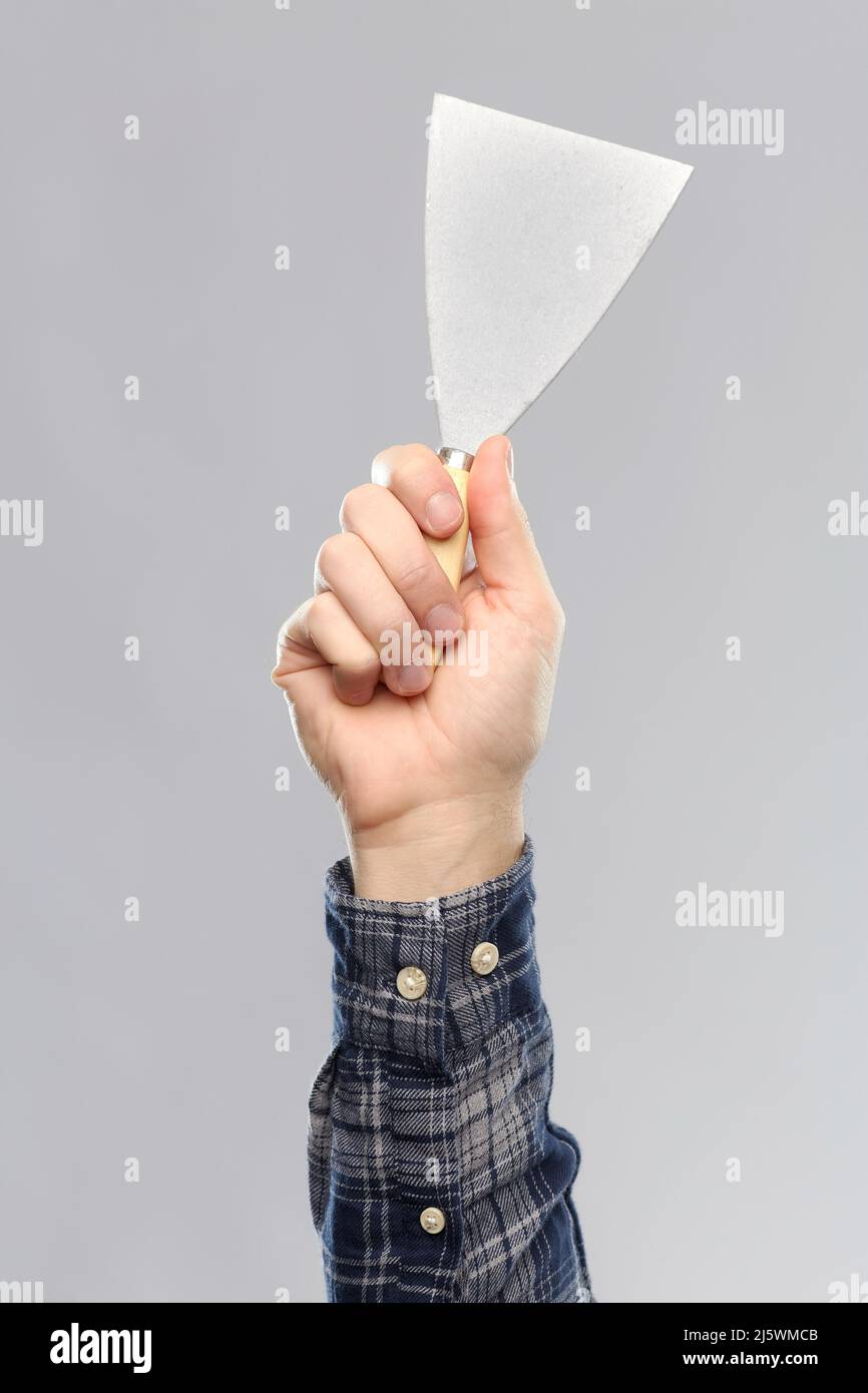 close up of builder's hand holding putty knife Stock Photo - Alamy