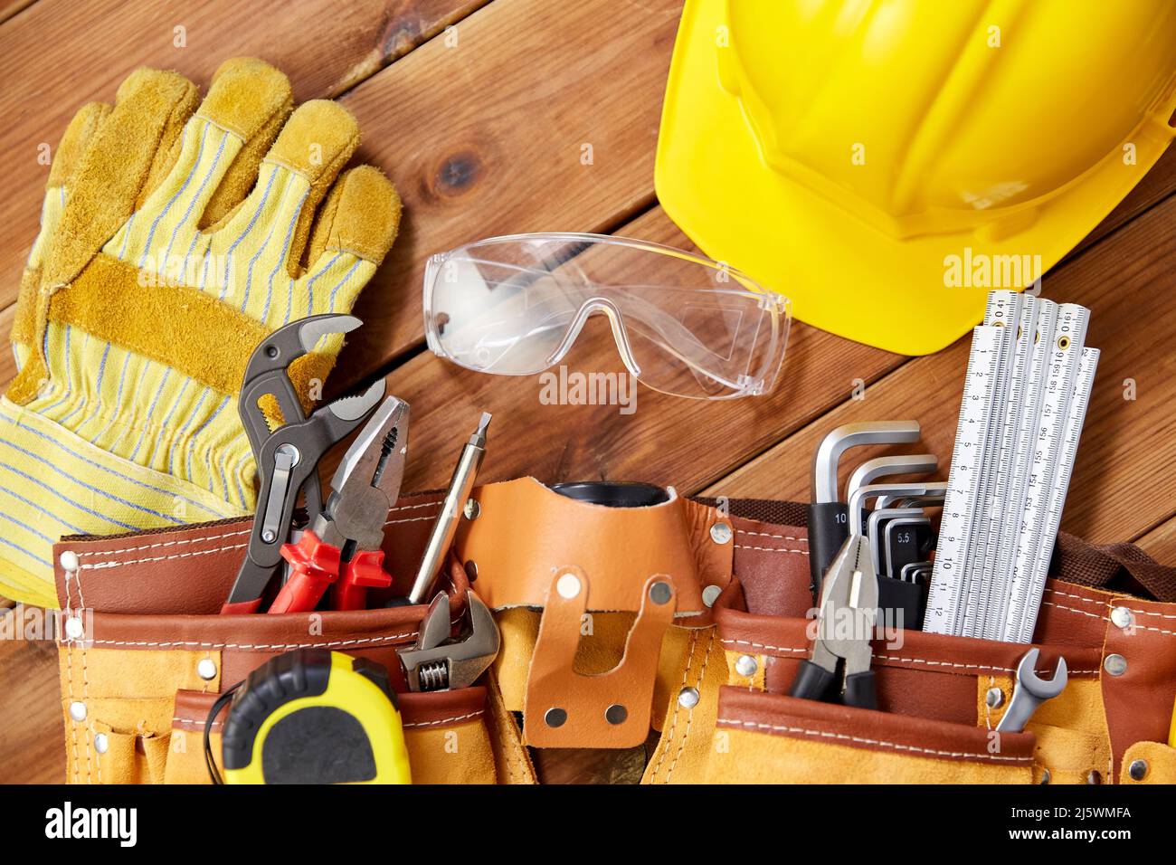 different work tools in belt on wooden boards Stock Photo - Alamy