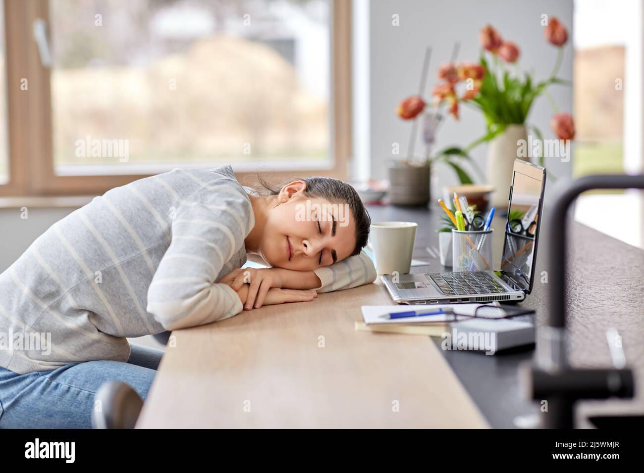 Woman lying on kitchen table hi-res stock photography and images - Alamy
